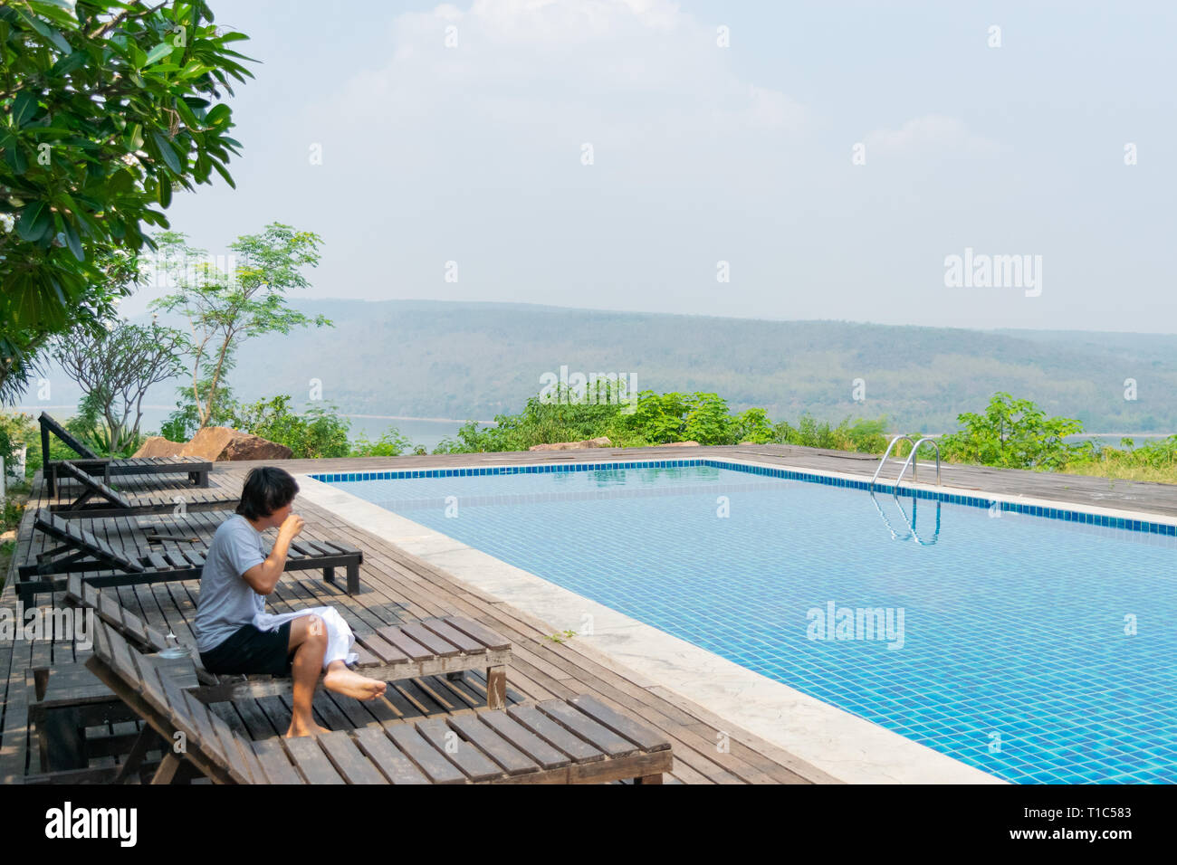 Someone relax at the resort pool on holiday Stock Photo - Alamy