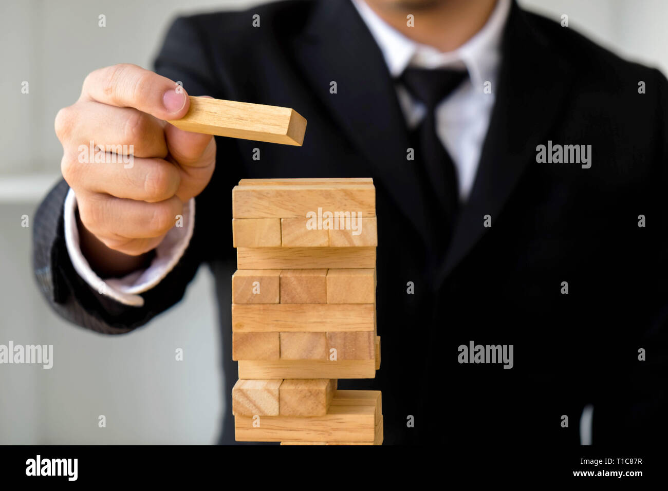 Businessmen picking domino blocks to fill the missing dominos. Growing ...