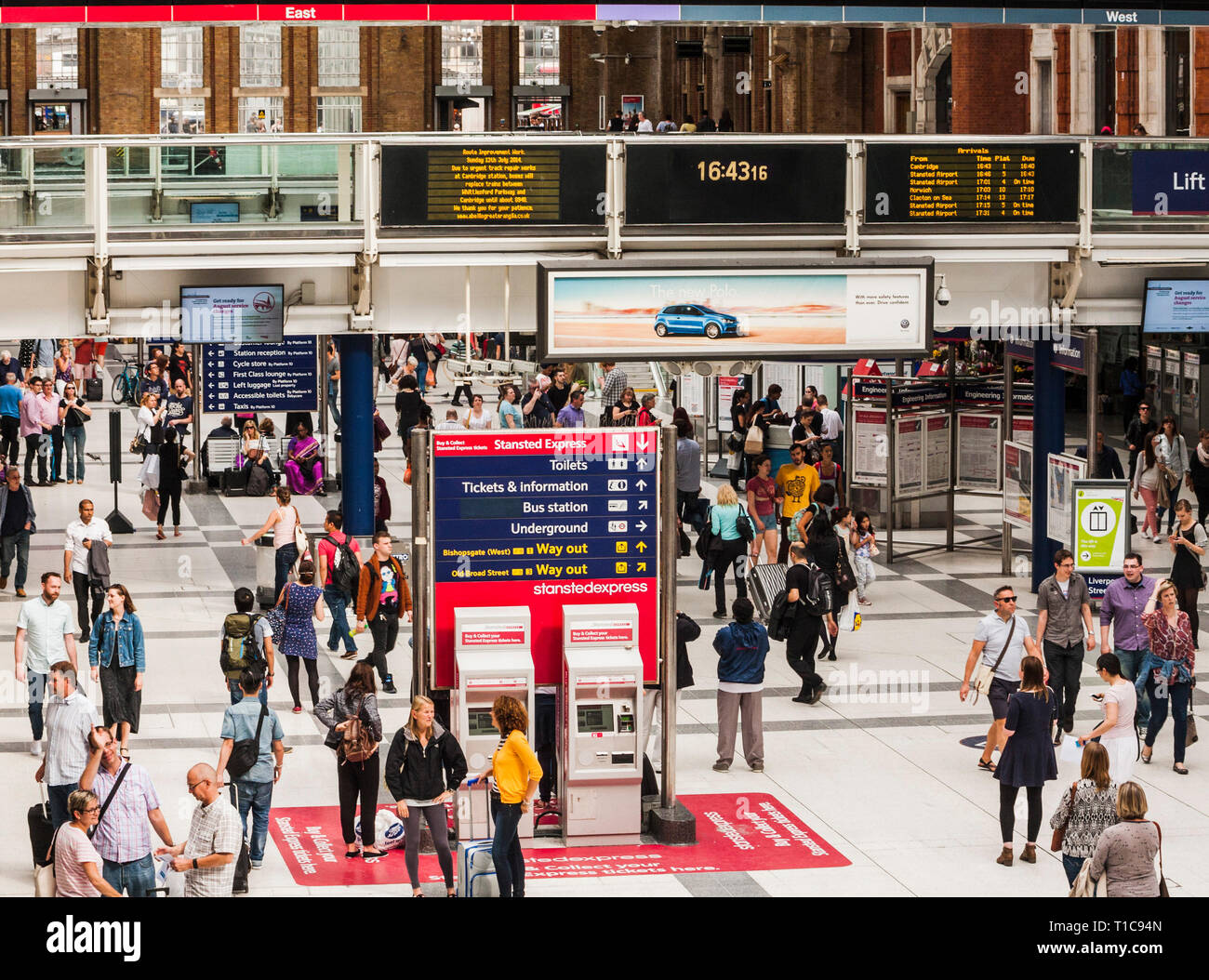 View of the busy Liverpool Street station in London featuring signage ...
