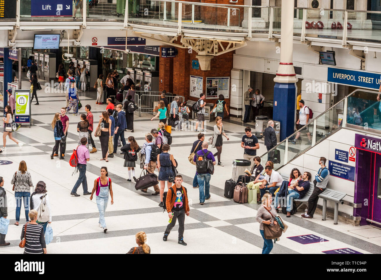 View of the busy Liverpool Street station in London featuring signage ...