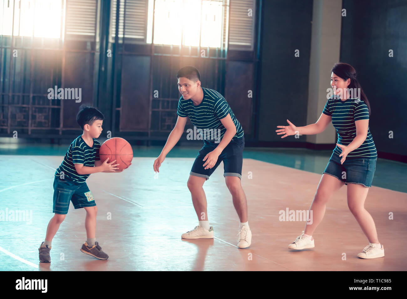 Asian family playing basketball together. Happy family spending free ...