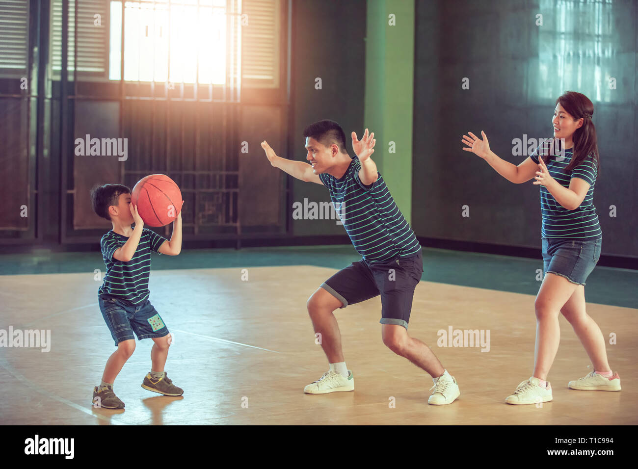Asian family playing basketball together. Happy family spending free ...