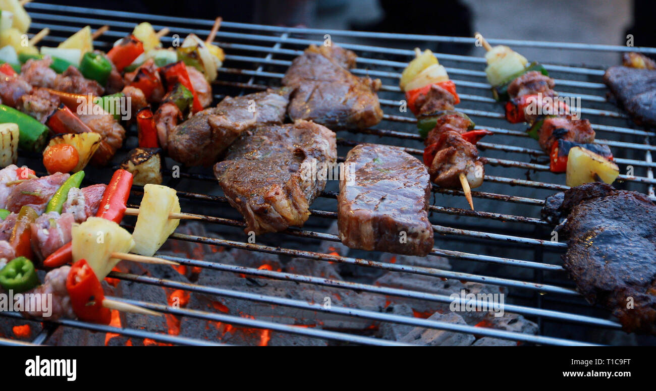 Asian group of friends having outdoor garden barbecue laughing with ...