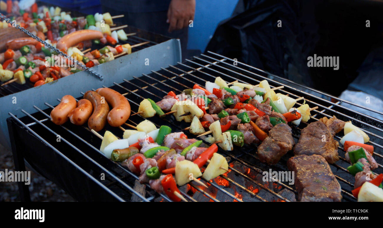 Asian group of friends having outdoor garden barbecue laughing with ...