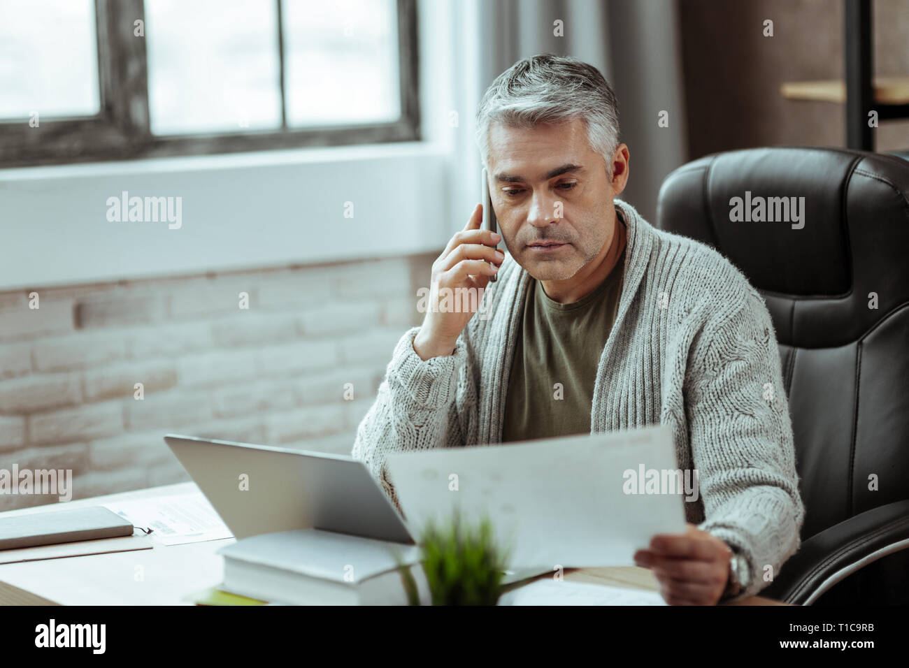 Smart serious mature man making a call Stock Photo - Alamy