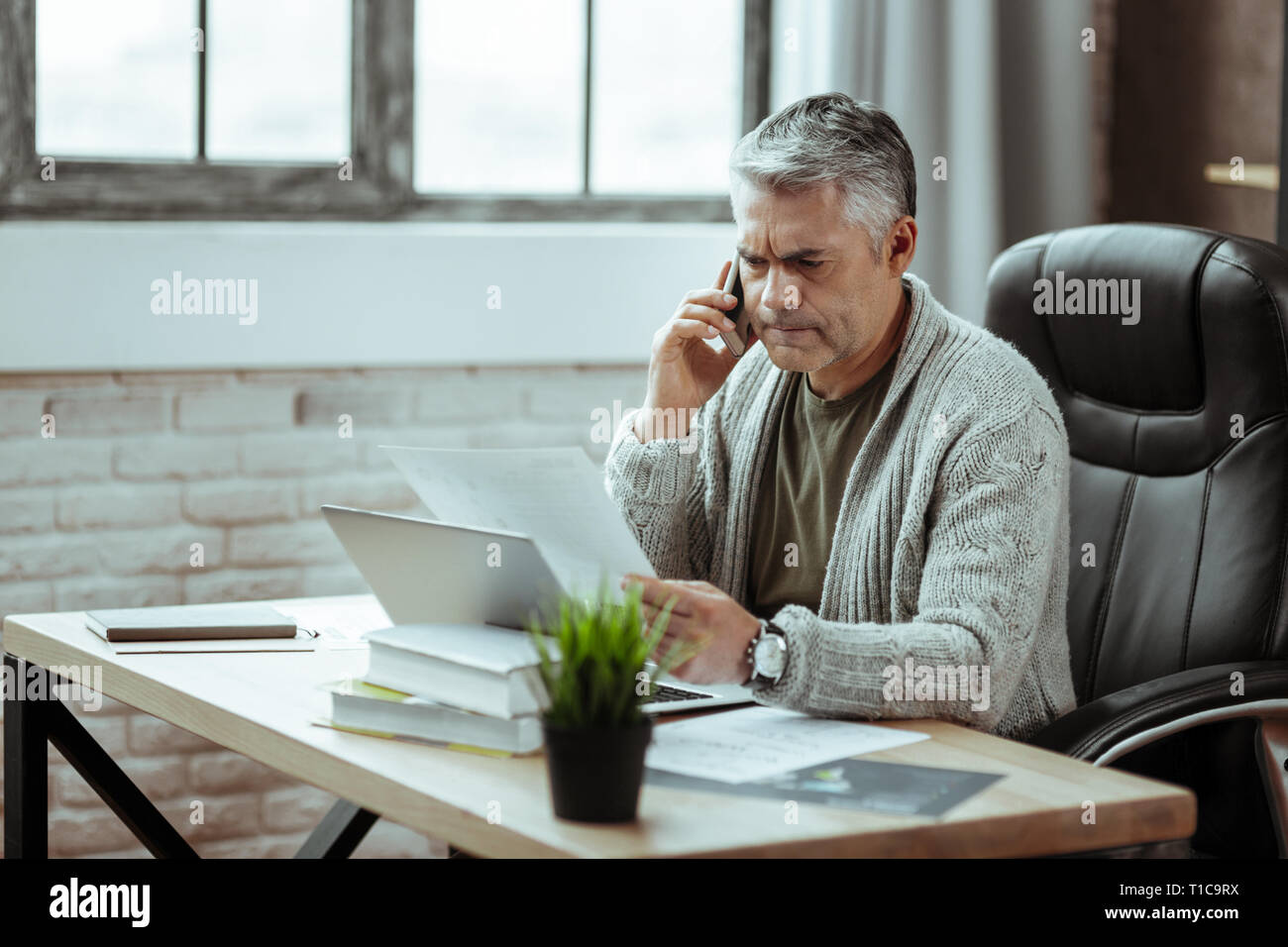 Nice serious man thinking about his work Stock Photo - Alamy