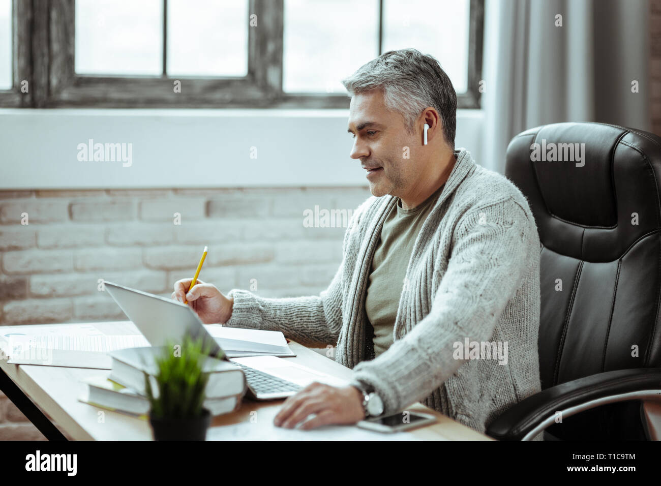 Positive happy man looking at the laptop screen Stock Photo - Alamy