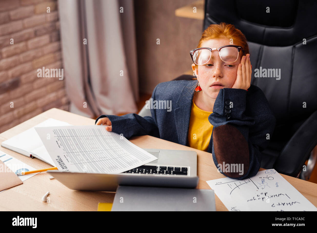 Nice cute girl being bored with work Stock Photo - Alamy