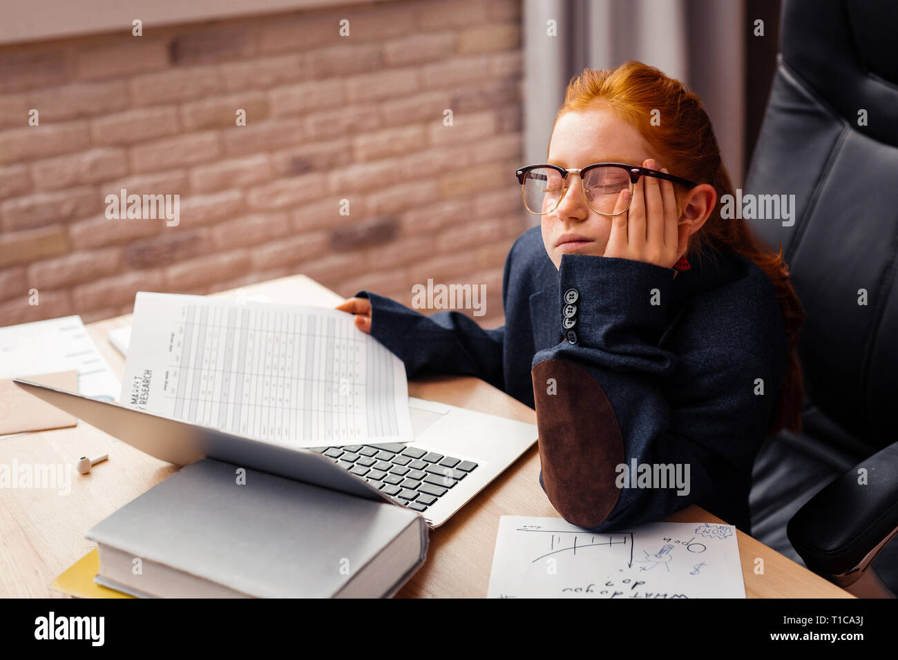 Cute nice red haired girl falling asleep Stock Photo - Alamy