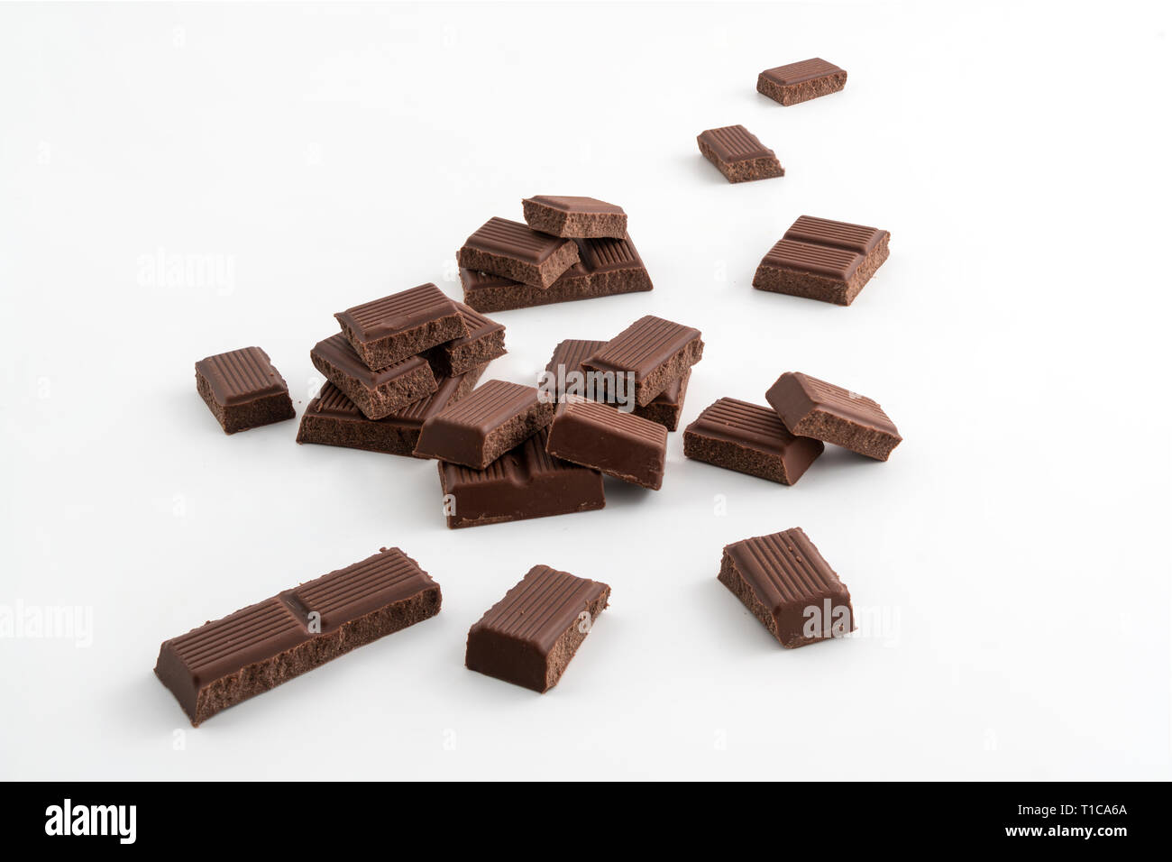 a chocolate bar chopped on a white surface Stock Photo - Alamy