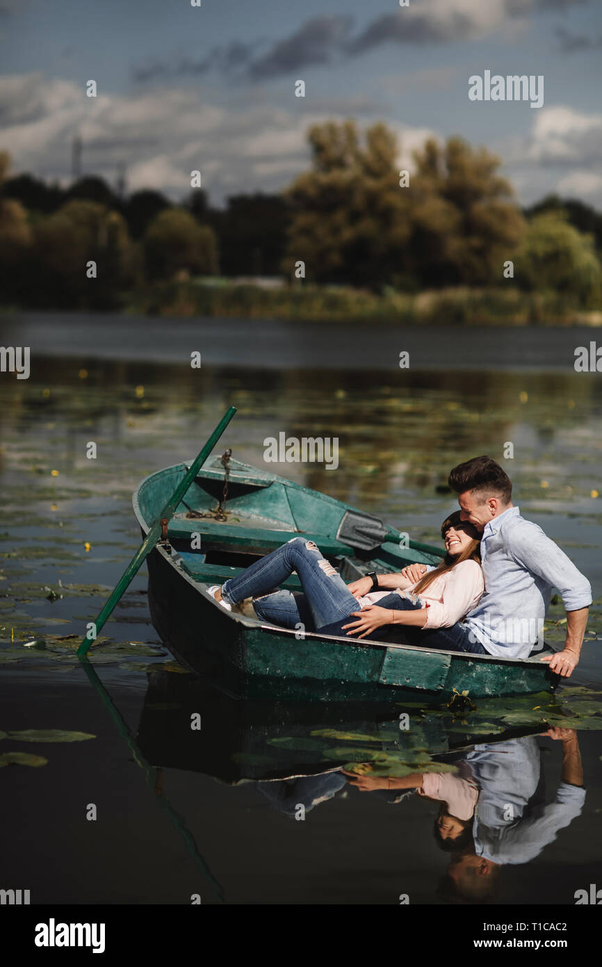 Just relaxing. Beautiful young couple enjoying romantic date while ...