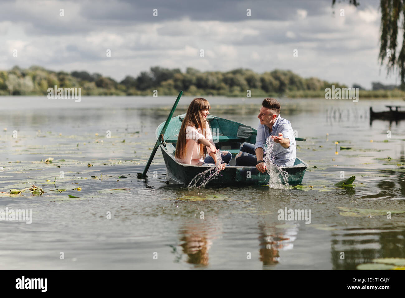 Feeling playful. Beautiful young couple enjoying romantic date while ...