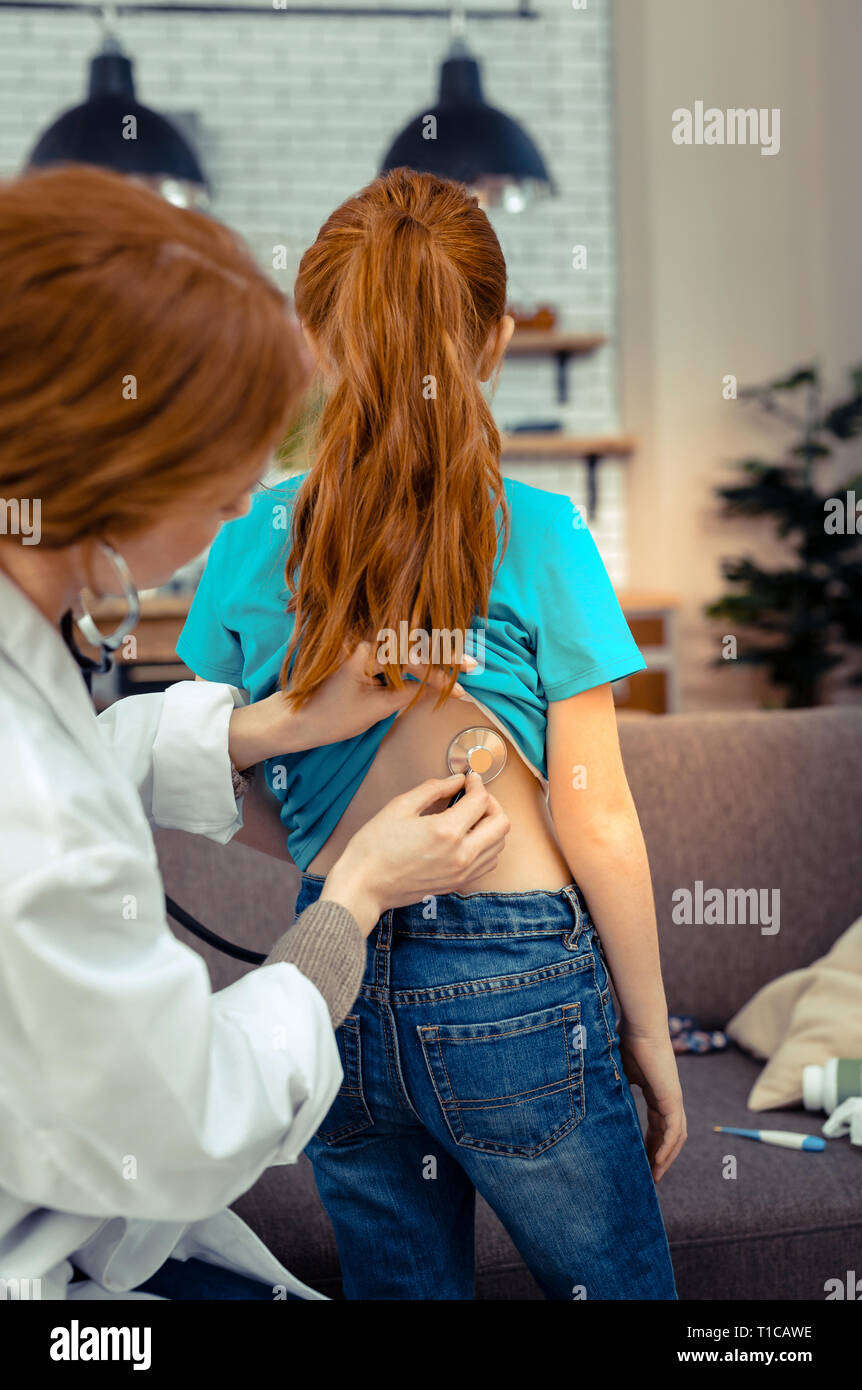 Nice pleasant girl having her health checked Stock Photo - Alamy