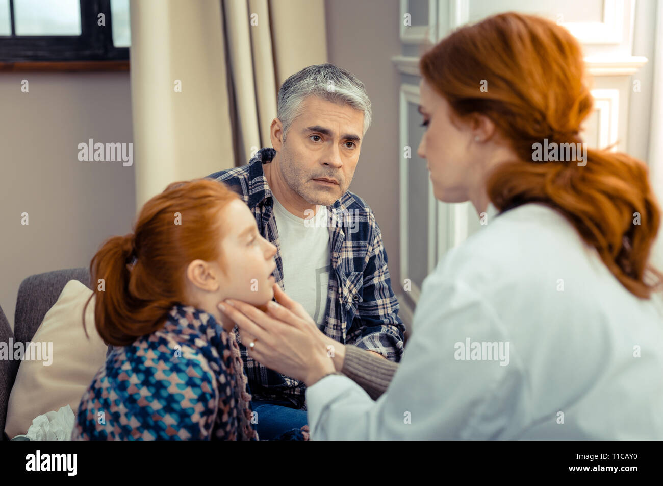 Sad worried father looking at the doctor Stock Photo - Alamy