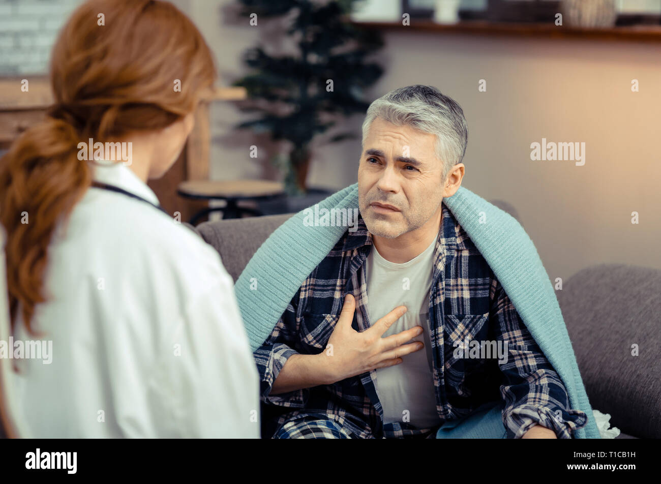 Sad cheerless man speaking about his symptoms Stock Photo - Alamy