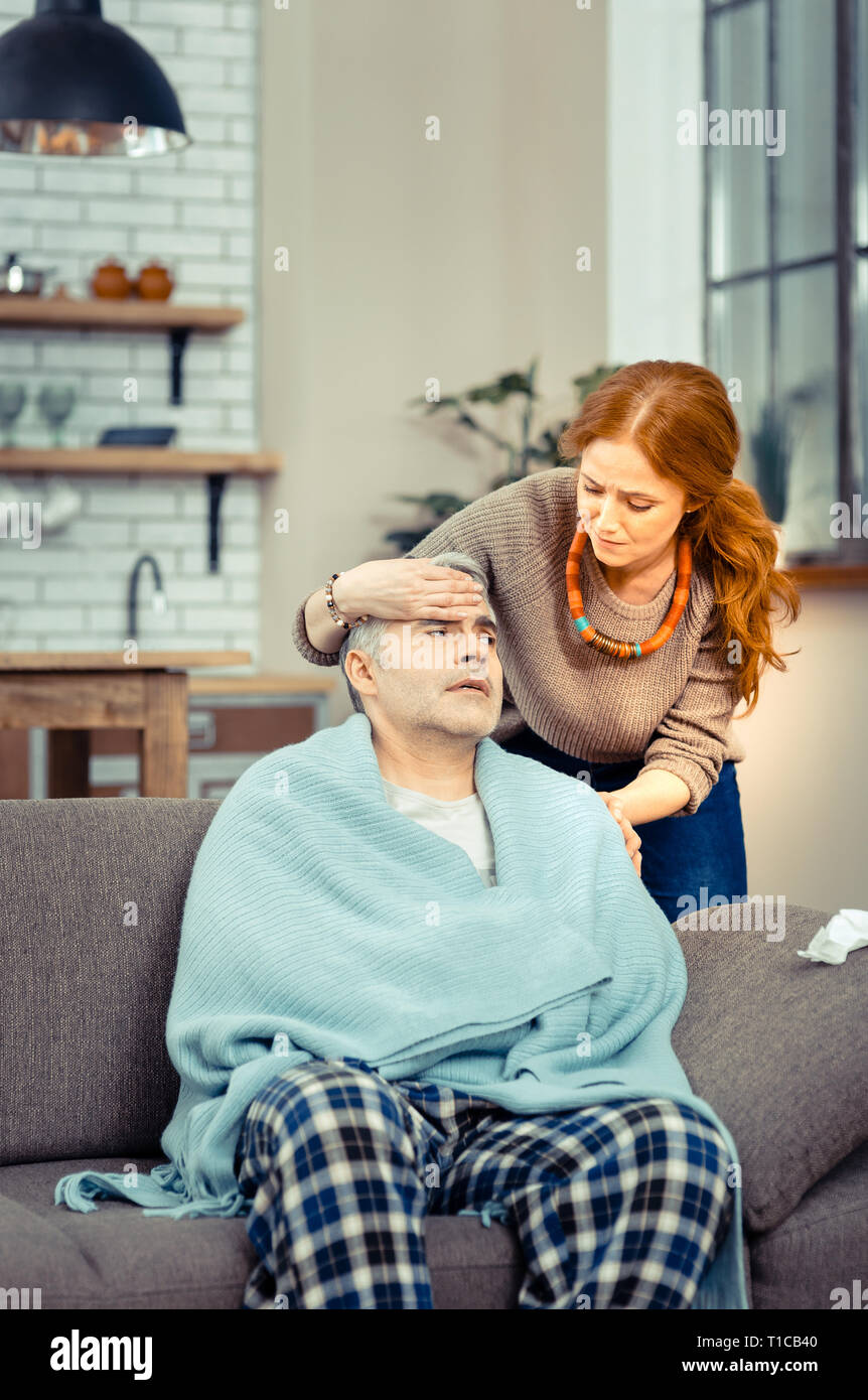 Nice caring woman standing behind her husband Stock Photo - Alamy