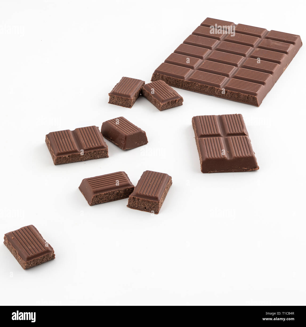 a chocolate bar chopped on a white surface Stock Photo - Alamy
