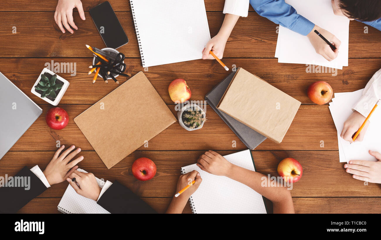 School lesson. Children drawing and doing homework Stock Photo - Alamy