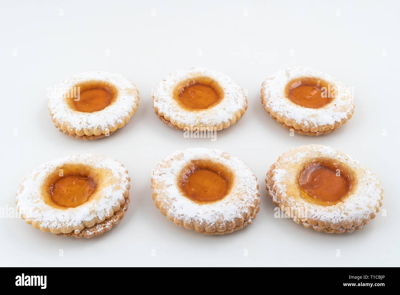 round pastries of pastry and jam on a white surface Stock Photo - Alamy
