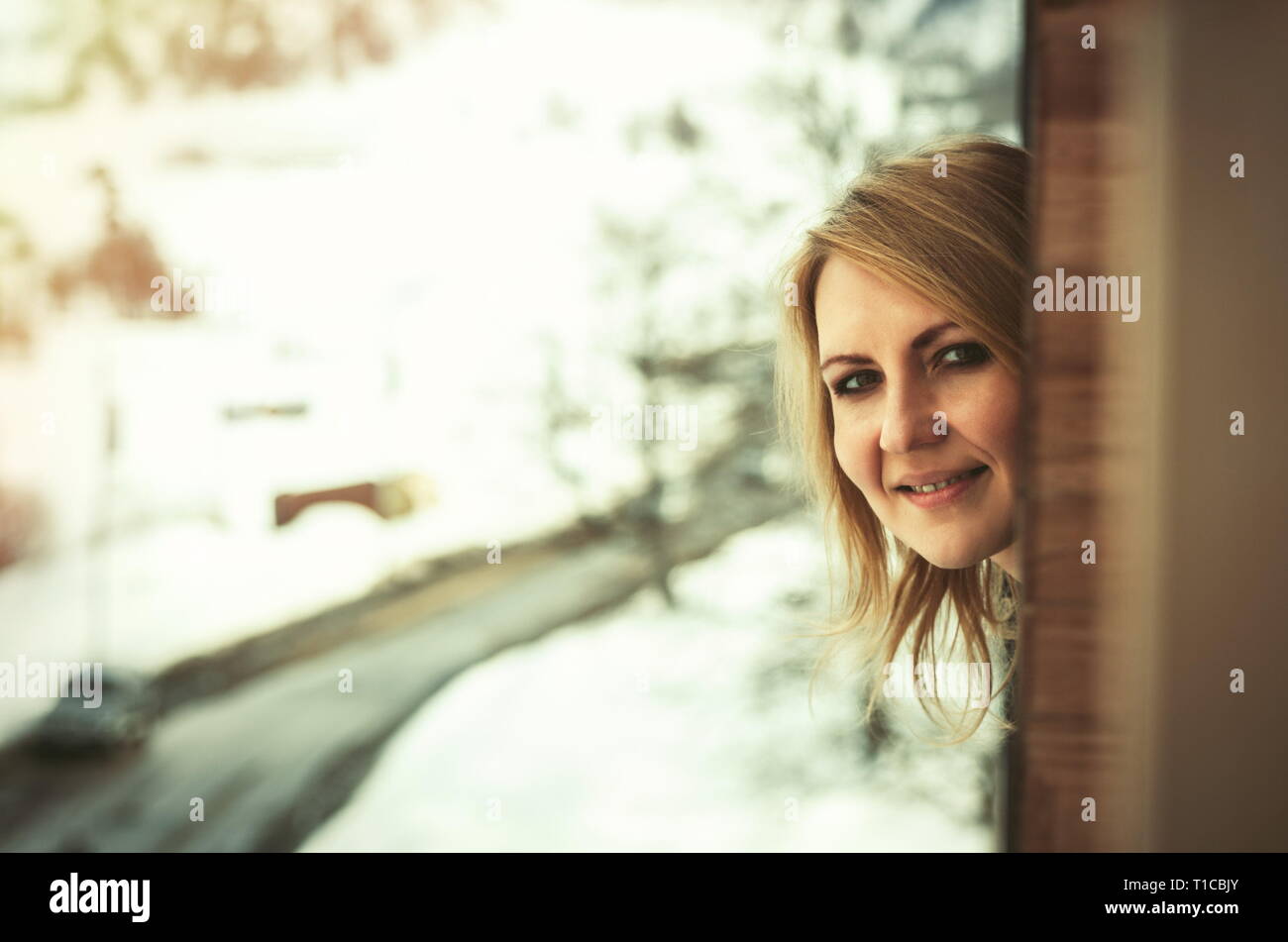 Happy woman by winter window indoor hi-res stock photography and images ...
