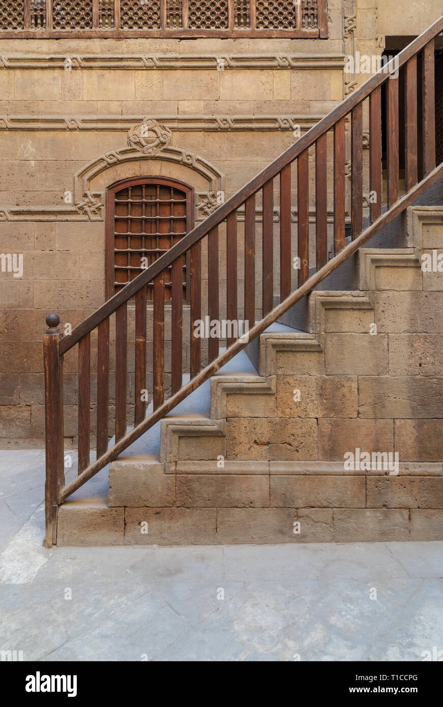 Wooden window and staircase with wooden balustrade leading to historic ...