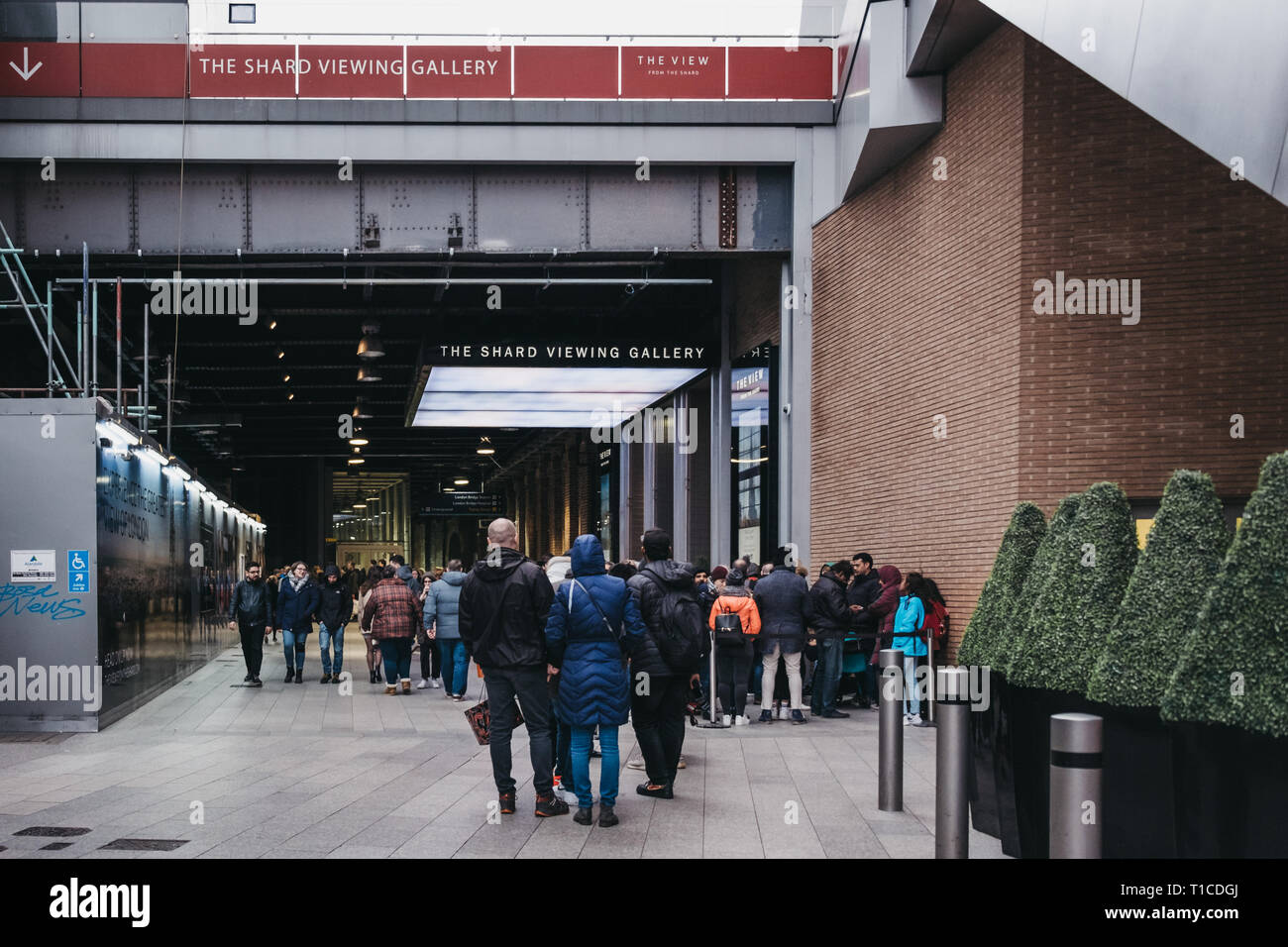 London, UK - March 16, 2019: People queuing on a street to enter the ...