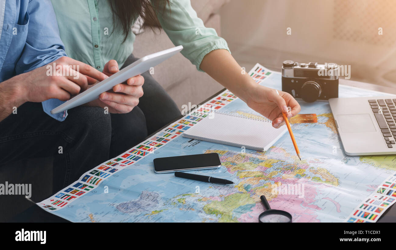 Planning trip. Couple discussing tour plans using map Stock Photo - Alamy