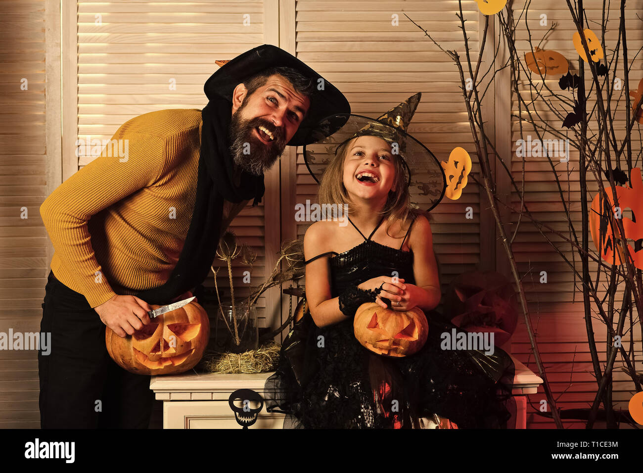 Father and daughter with Halloween decor. Wizard and little witch Stock ...