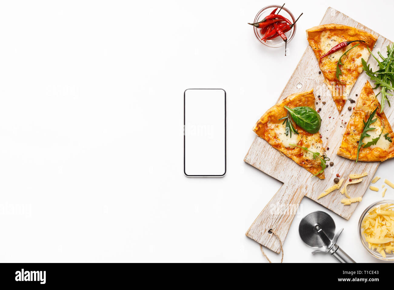 Pizza slices and smartphone with blank screen Stock Photo - Alamy