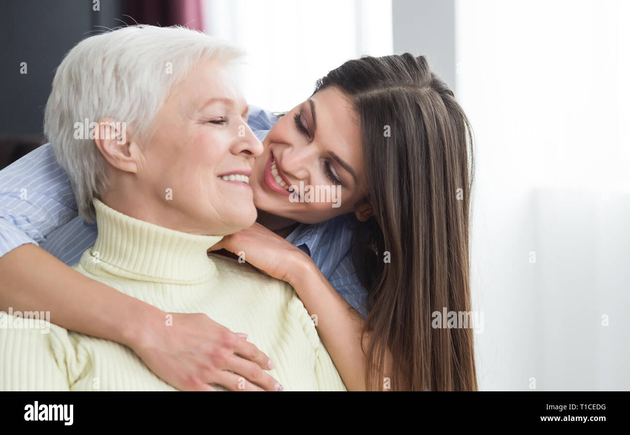 Happy daughter hugging her mother with love Stock Photo - Alamy