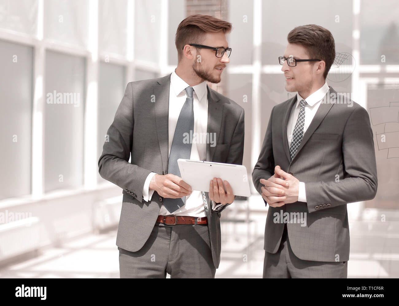 two employees standing in the office Stock Photo - Alamy