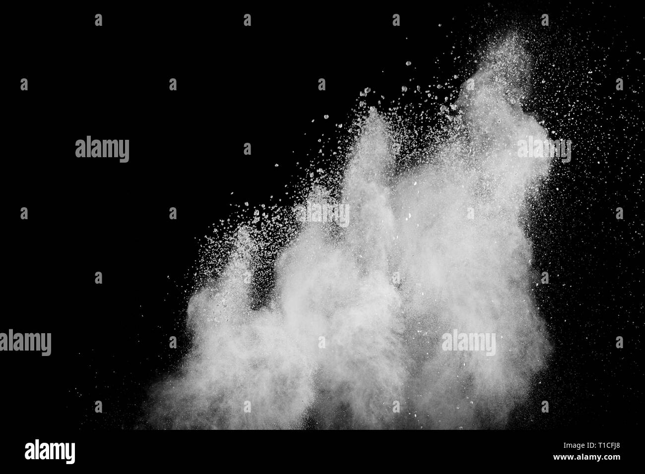 White powder explosion.Freeze motion of white dust particles on black ...