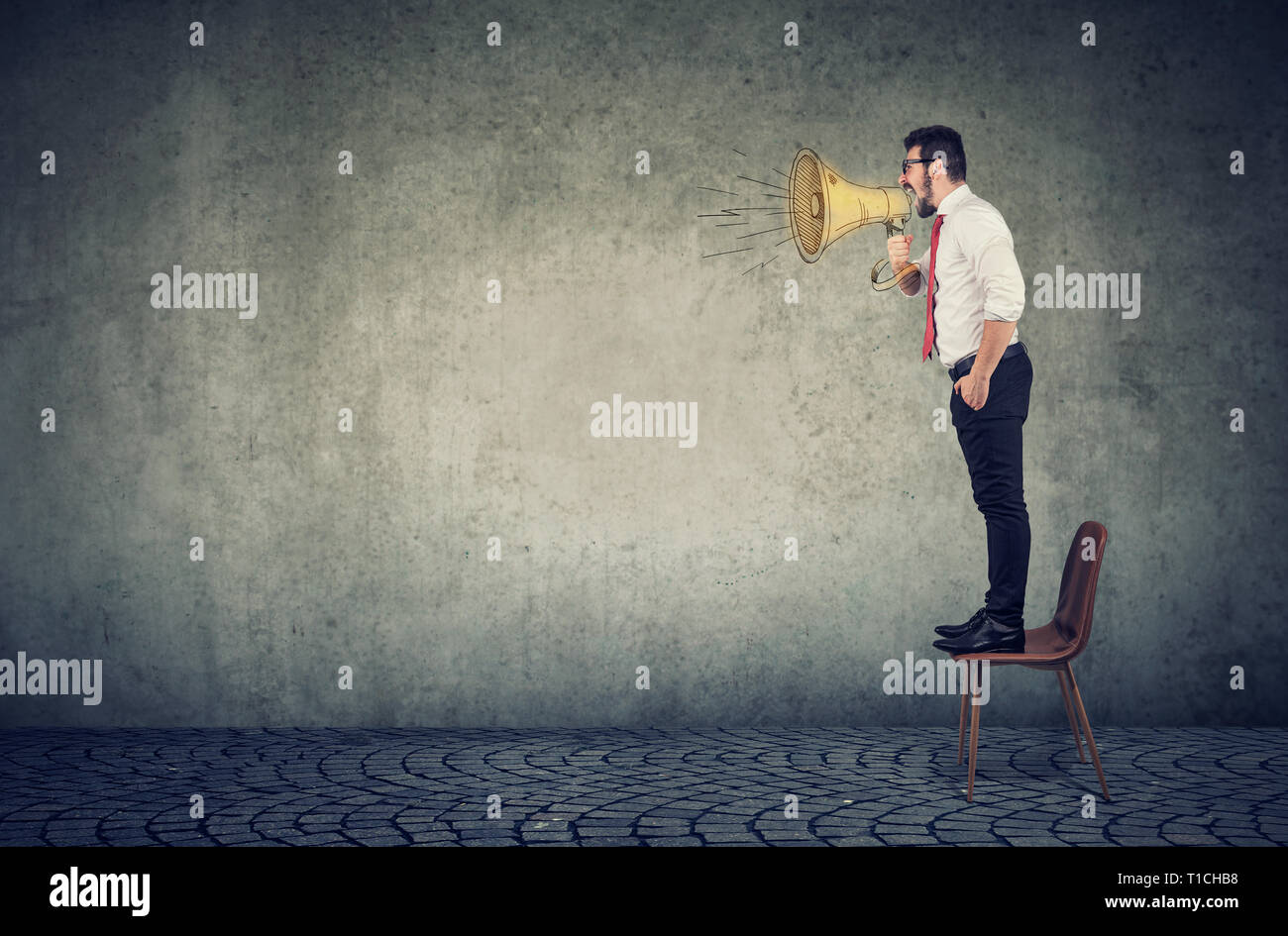 Beard business man standing on a chair and screaming into a megaphone ...