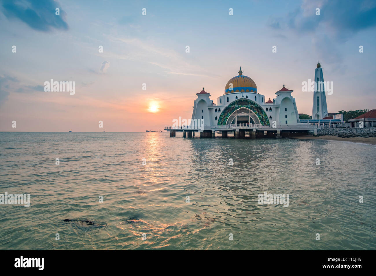 Sunset over Melaka Straits Mosque, located in Malaysia, and built using ...