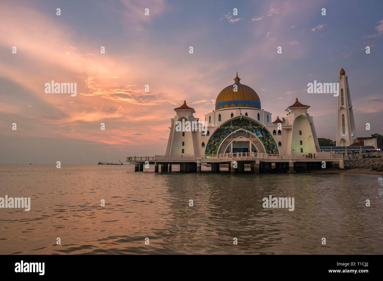 Sunset over Melaka Straits Mosque, located in Malaysia, and built using ...
