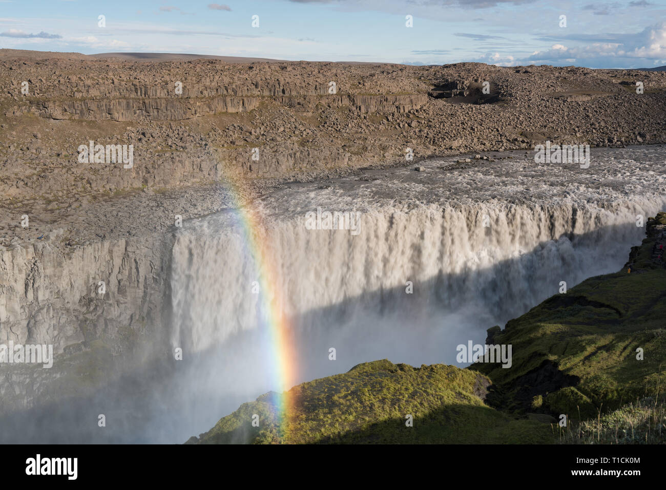 The most powerful waterfall in Europe - majestic Dettifoss in Iceland with a beautiful rainbow ...