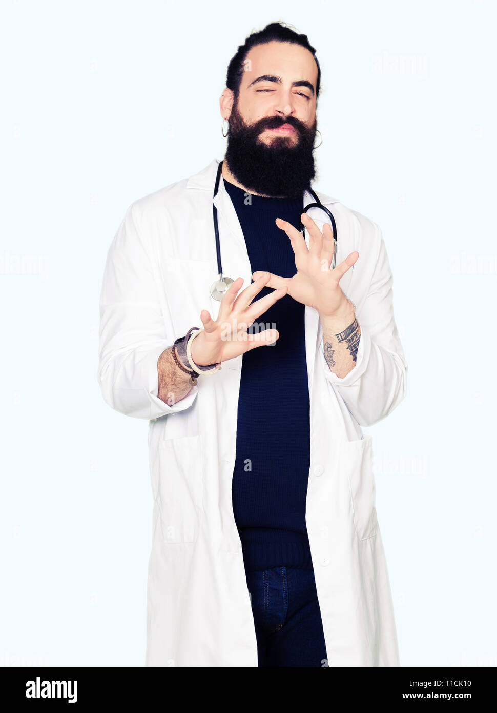 Doctor with long hair wearing medical coat and stethoscope disgusted ...
