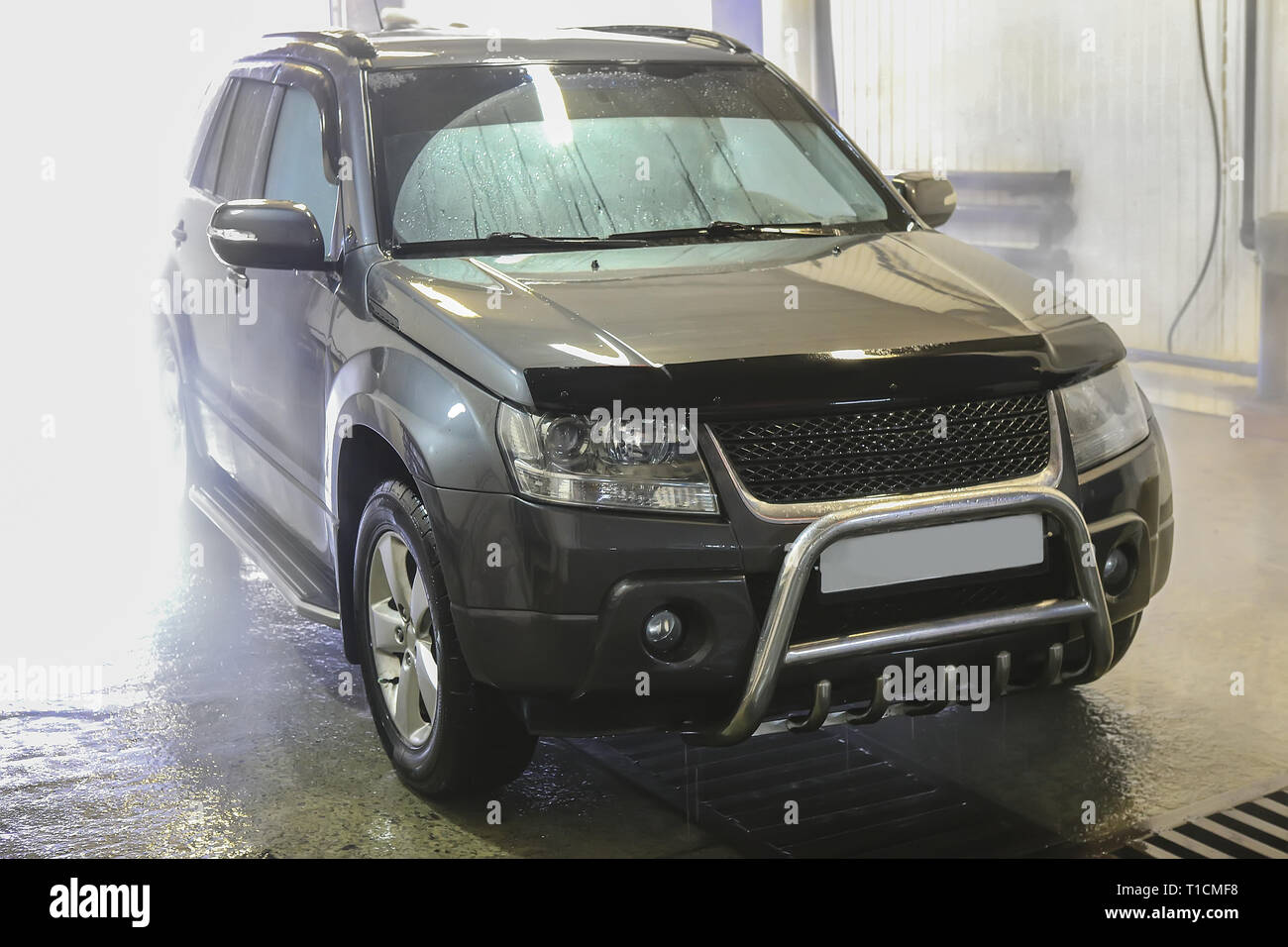 A car under streams of water in a car wash Stock Photo - Alamy
