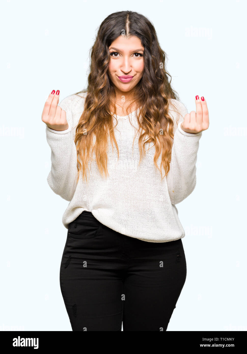Young beautiful woman wearing white sweater Doing money gesture with ...