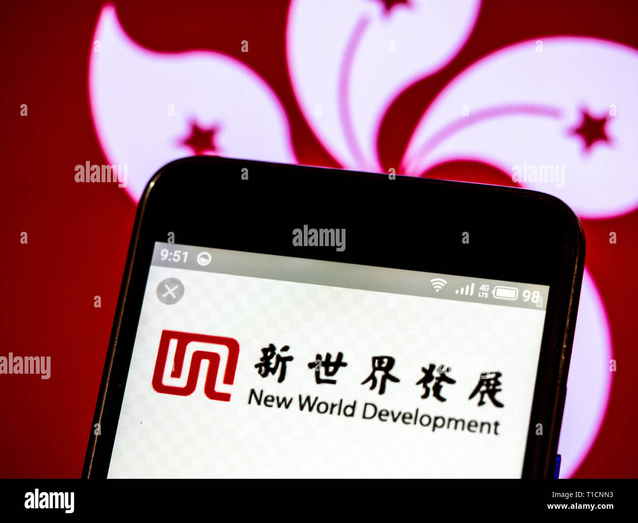 In this photo illustration a New World Development logo seen displayed ...