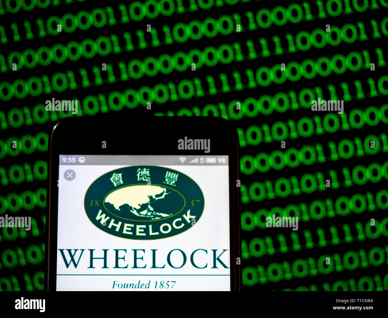 In this photo illustration a Wheelock & Co logo seen displayed on a ...