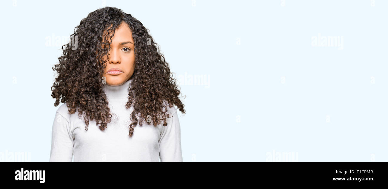 Young beautiful woman with curly hair wearing turtleneck sweater ...