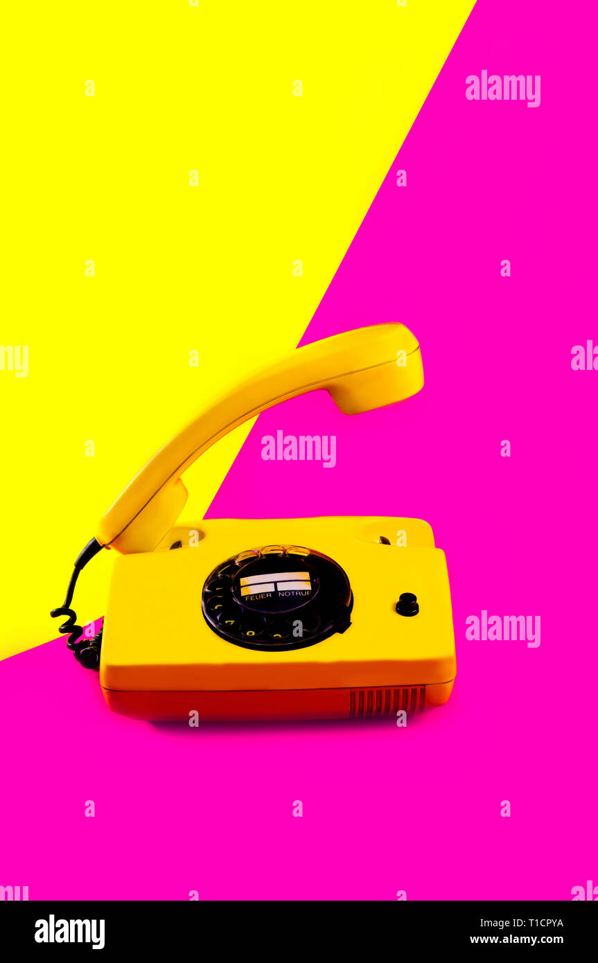 Yellow vintage phone on yellow and pink background. Retro telephone on ...