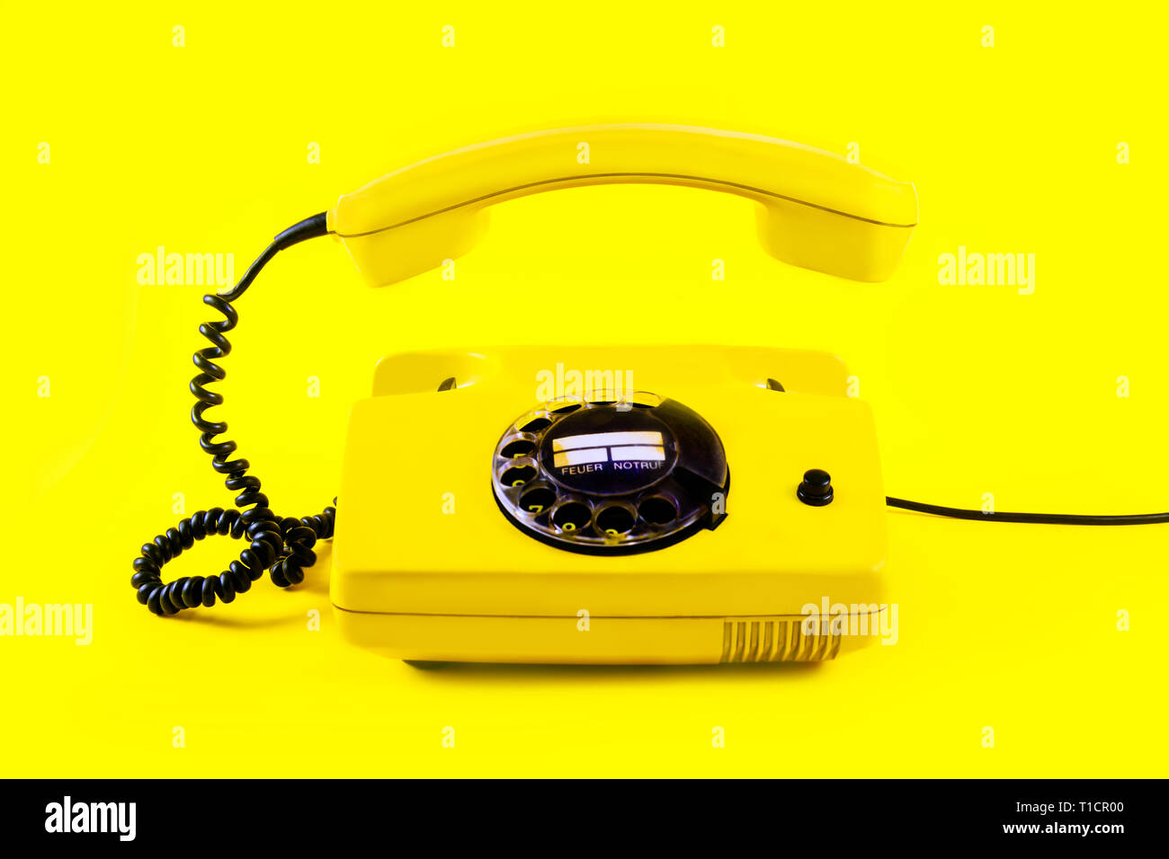 Yellow vintage phone on yellow background. Retro telephone on orange ...