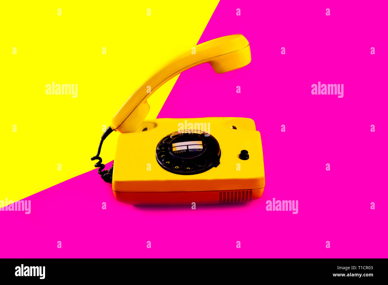 Yellow vintage phone on yellow and pink background. Retro telephone on ...