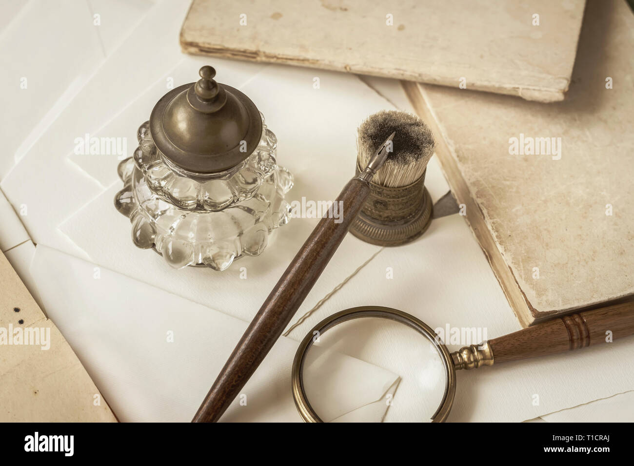Vintage stationery, wooden pen, inkwell, magnifier and envelopes ...