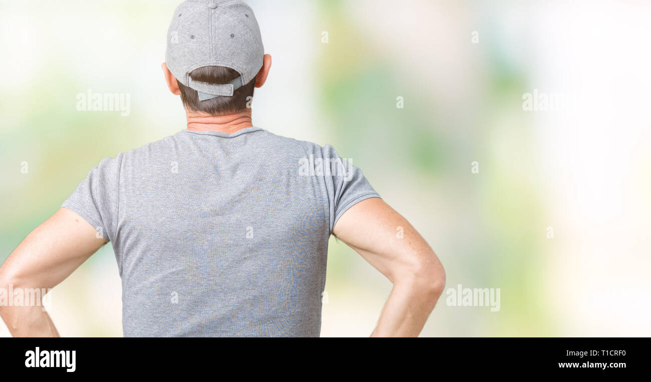 Handsome middle age hoary senior man wearing sport cap over isolated ...