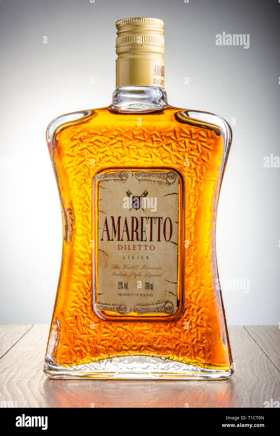 Bottle of Amaretto liqueur on gradient background. Amaretto comes from ...