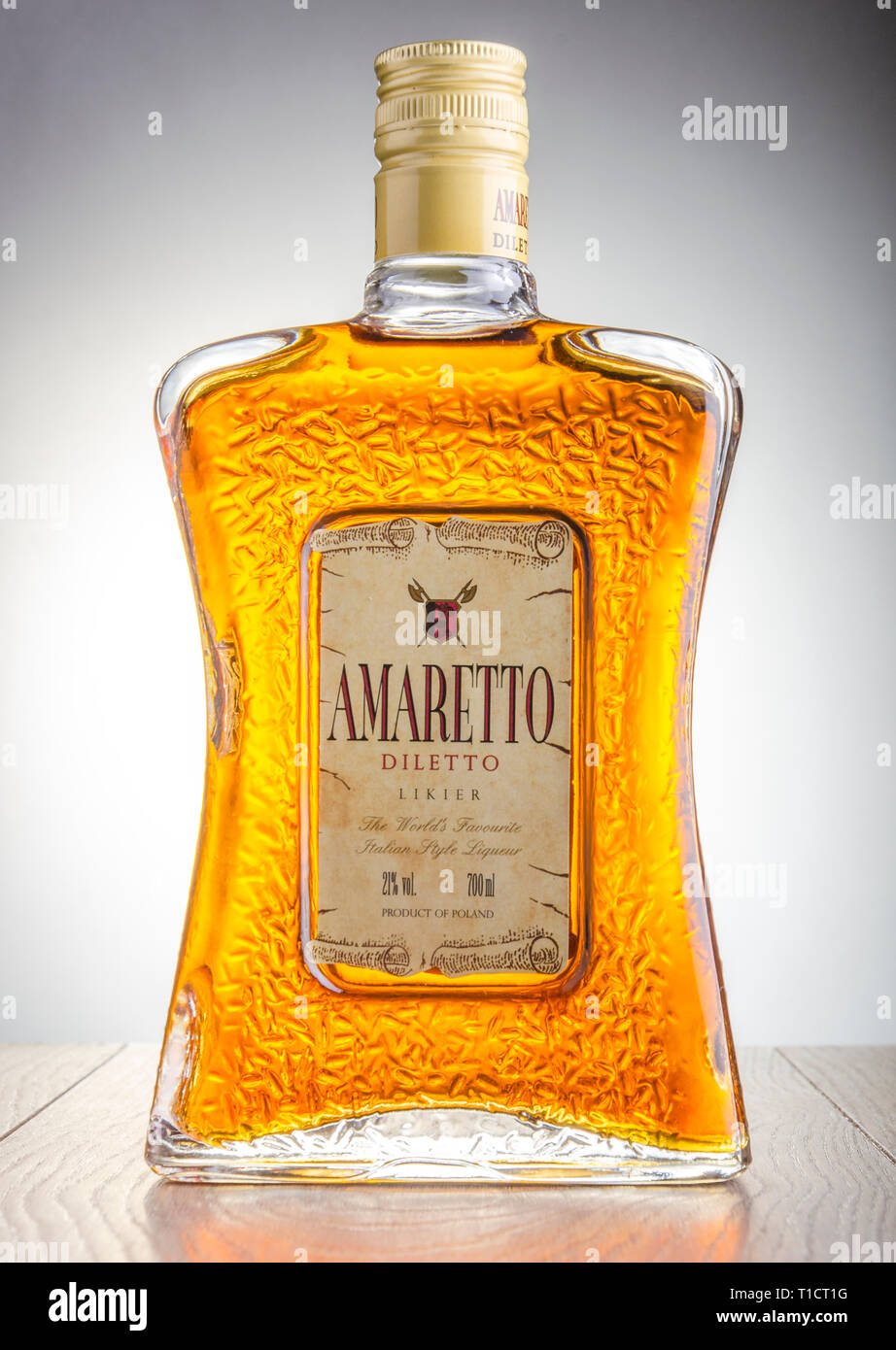Bottle of Amaretto liqueur on gradient background. Amaretto comes from ...