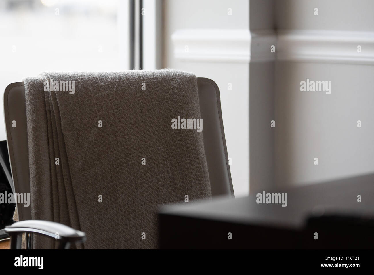 Cozy office chair in front of a bright window Stock Photo - Alamy